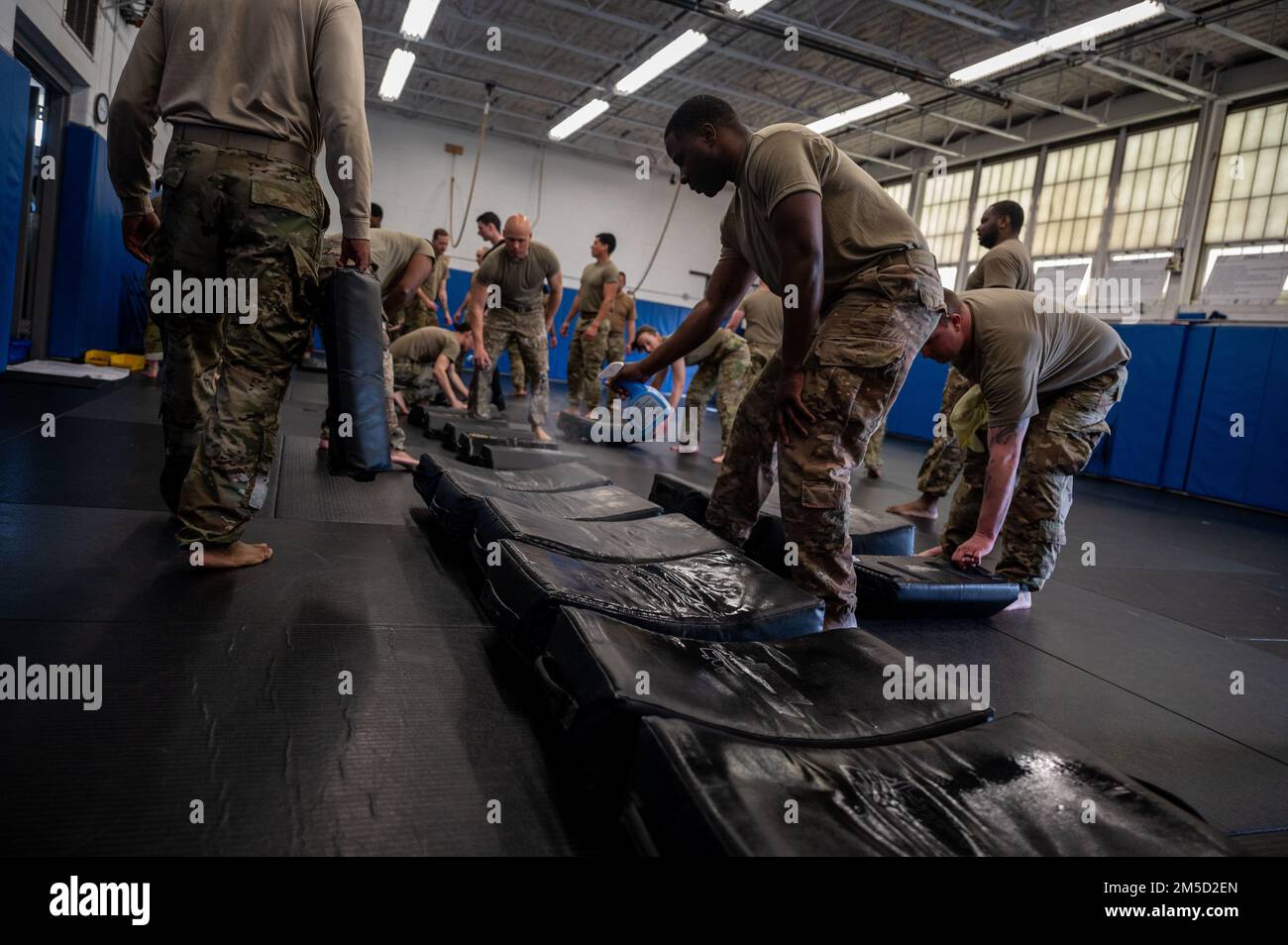 U.S. Air Force Airmen spray down mats during combatives training at ...
