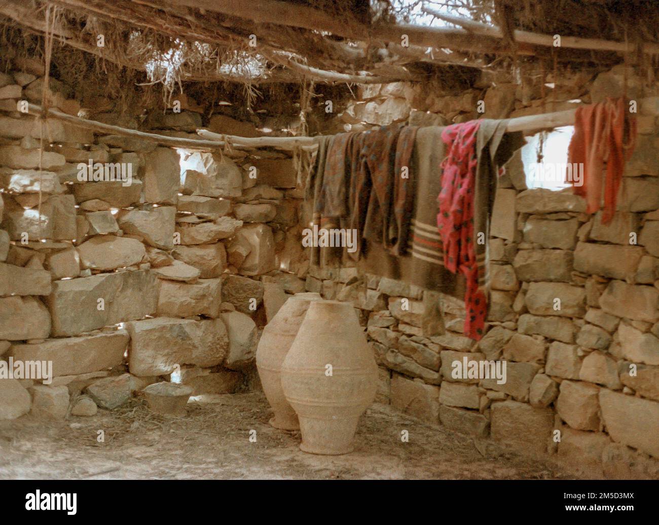 Earthenware pots occupy the stone village huts abandoned by members of ...