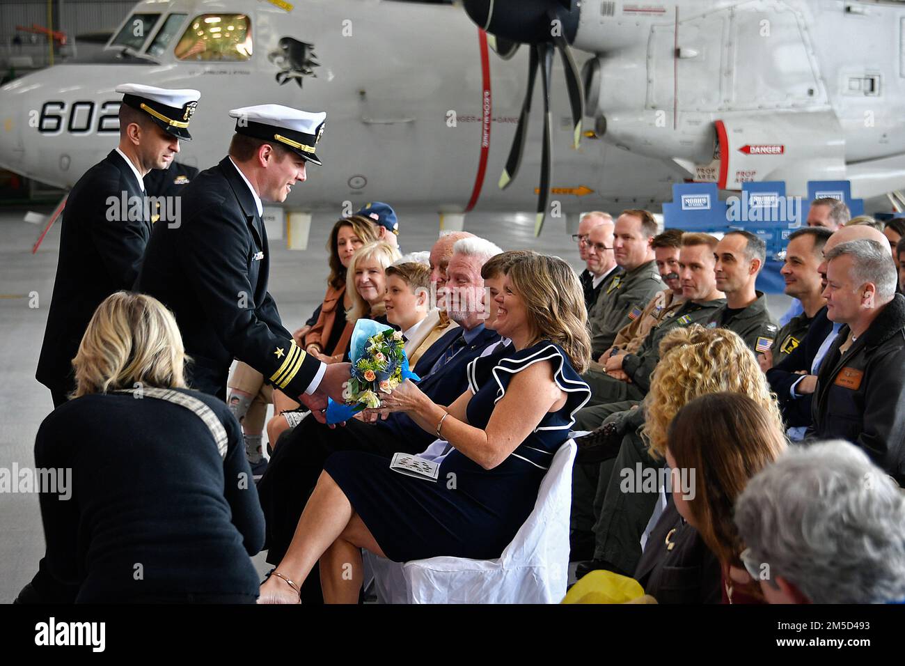 220303-N-AS200-4716 POINT MUGU, Calif. (Mar. 3, 2022) – Family members receive flowers during a ...