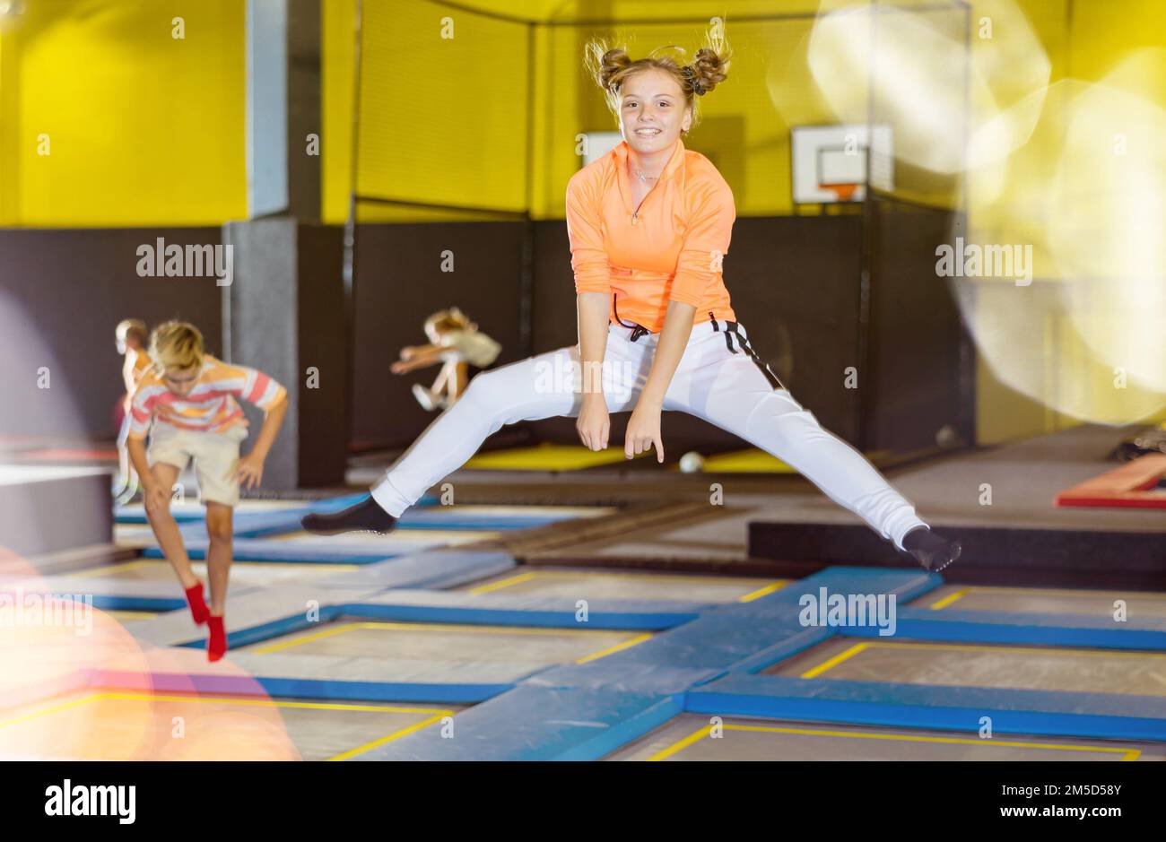Teenage girl having fun jumping in indoor trampoline arena Stock Photo ...