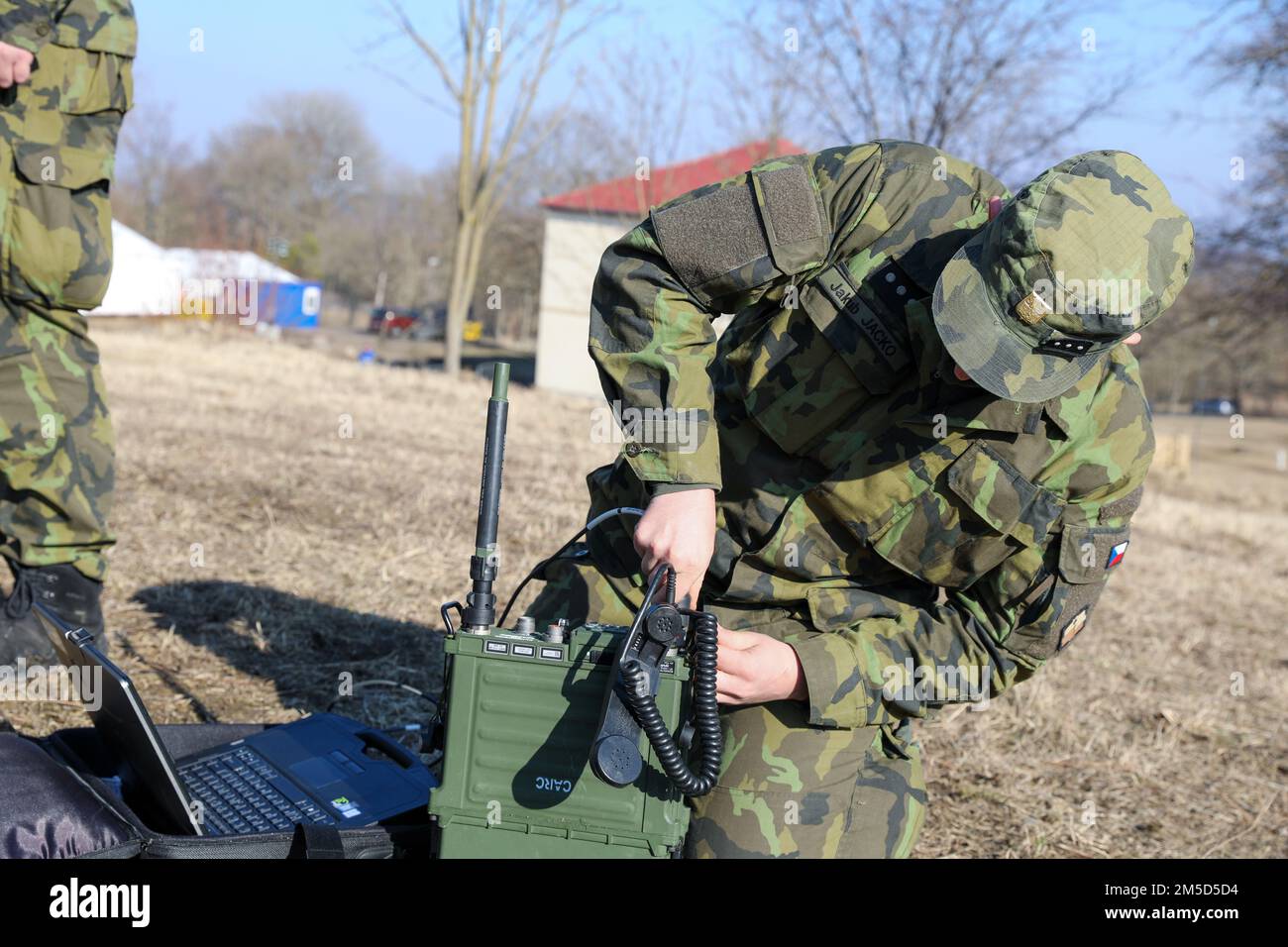 An enlisted soldier from the Czech army hooks up a radio as he works ...