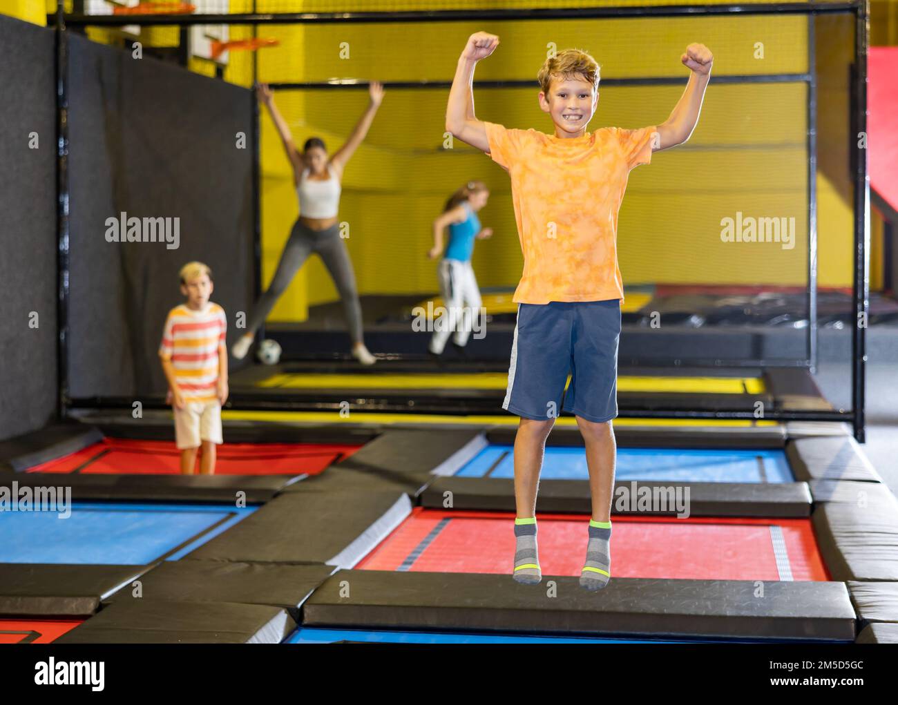 Preteen boy having while jumping in indoor trampoline arena Stock Photo ...