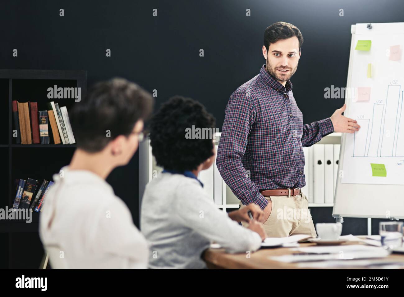 Take a look here for a second. a young businessman giving a ...