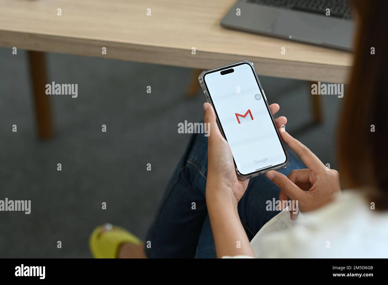 Chiang Mai, Thailand - Oct 08,2022: Woman iPhone 14 Pro Max with Gmail app on screen. Gmail is a ...