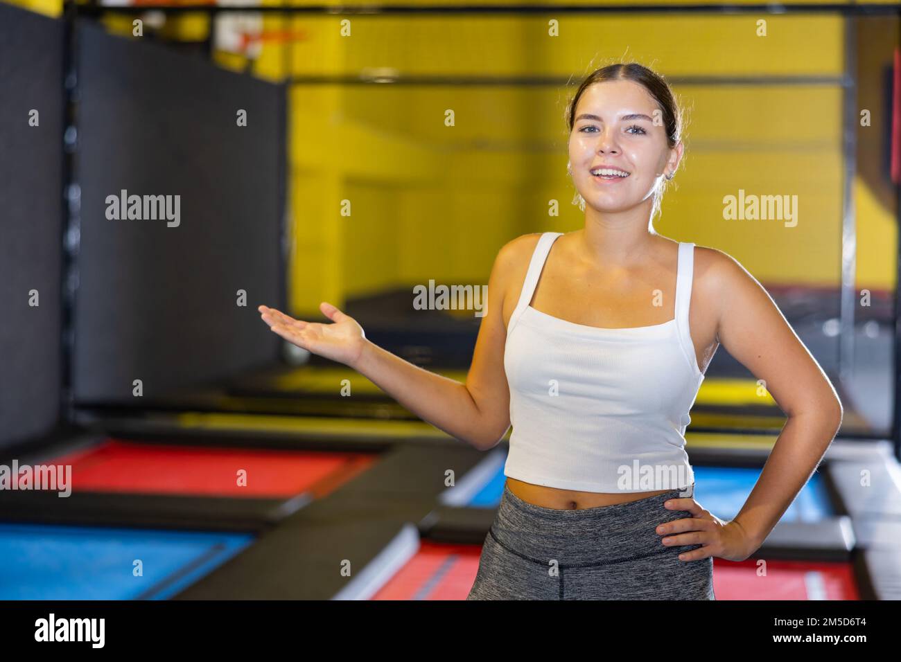 Woman trampolining coach against the background of children playing and ...