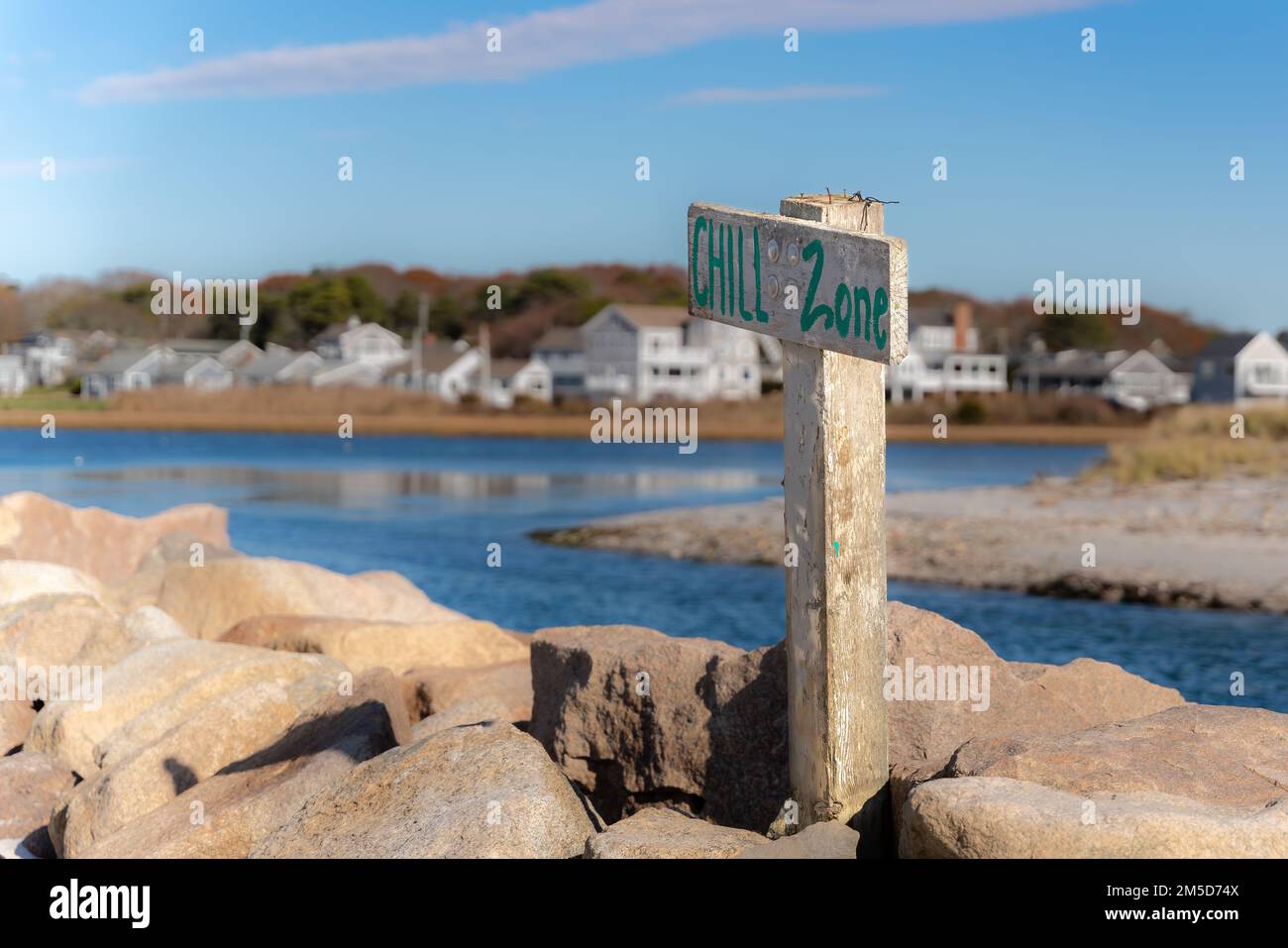 Horizontal photo, image of a wooden sign with post at a beach with ...