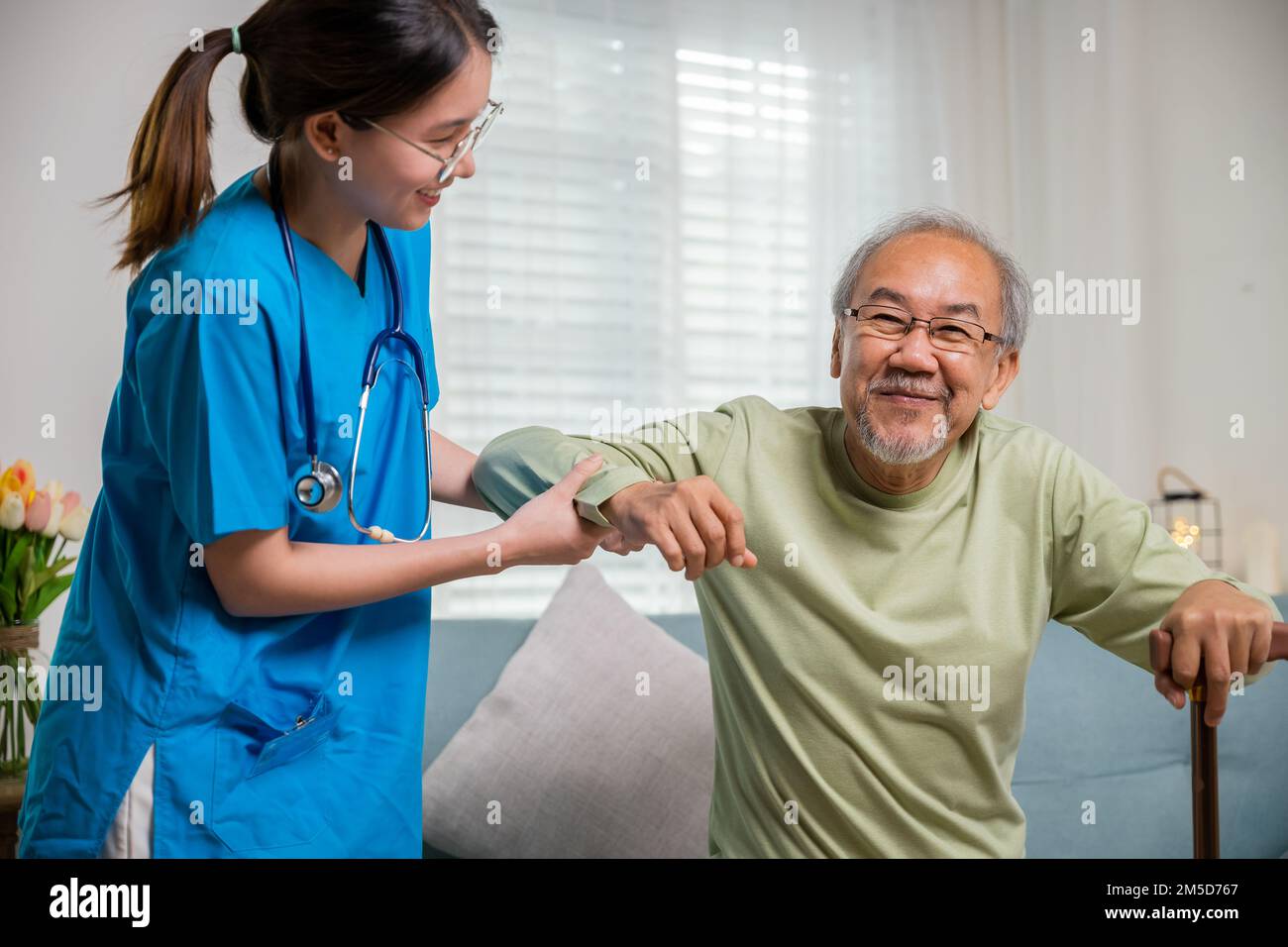 Young woman help support orthopedic patients to get up with walking ...