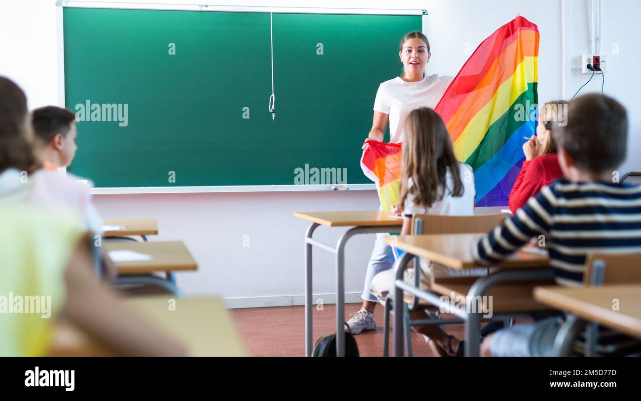 Female teacher explaining lgbt theme to children during lesson in class ...