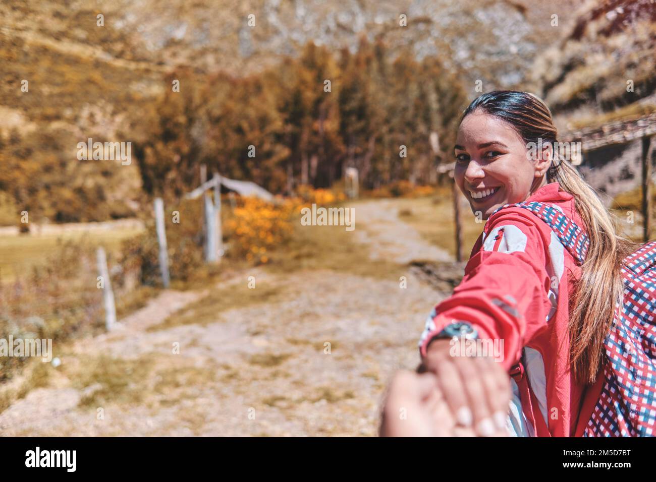 Closeup Young woman holding man hand while leading him on nature ...