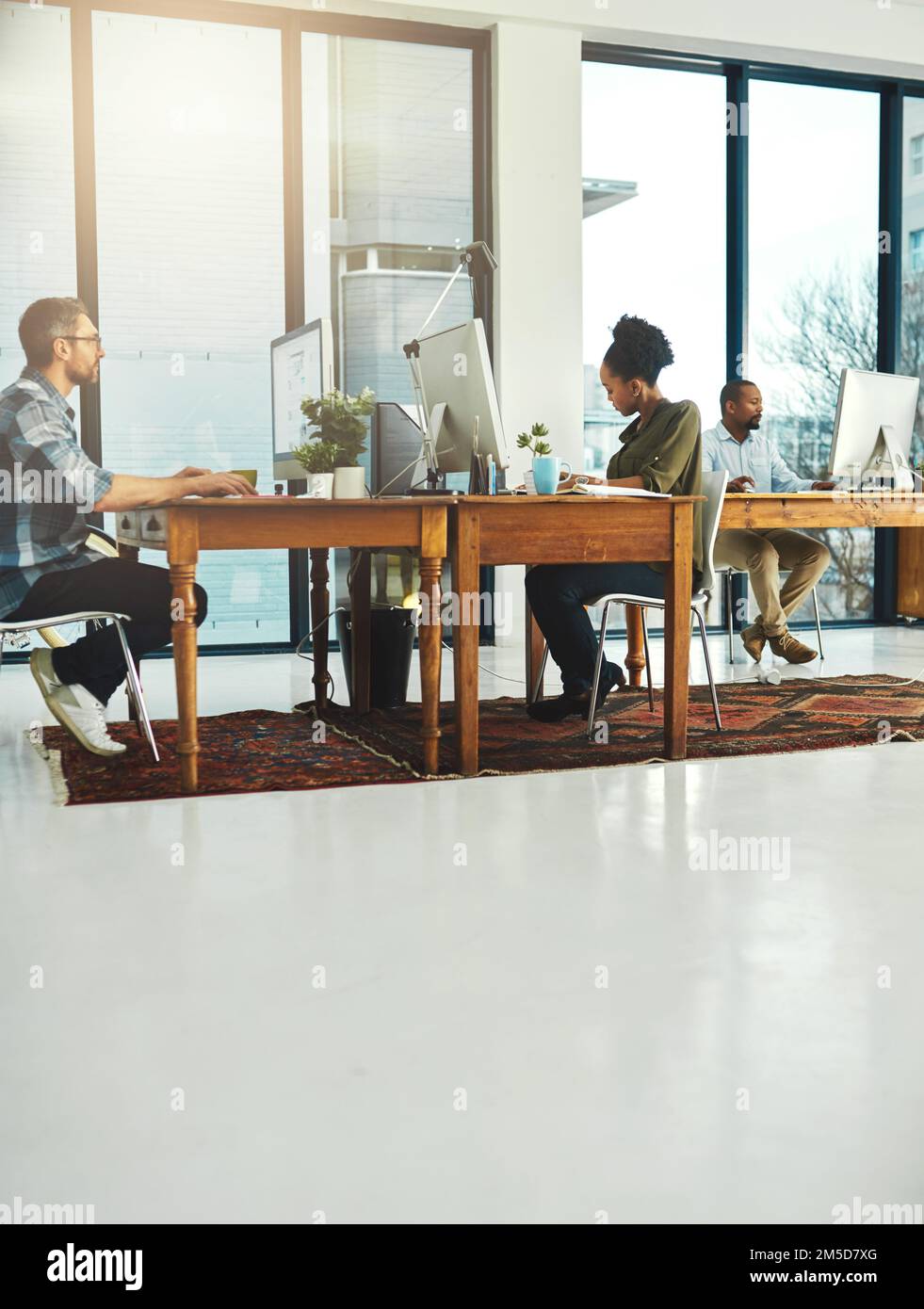 Focused on their individual tasks. two businesspeople working on ...