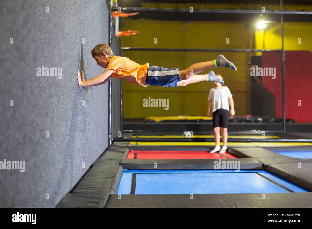 Tween boy jumping on trampoline on indoor inflatable playground Stock ...