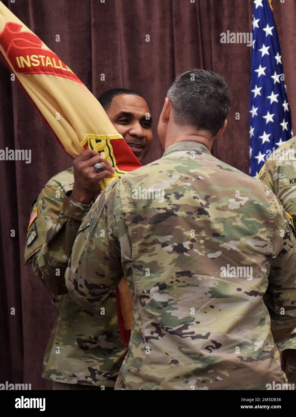 Command Sgt. Maj. Andre L. Welch accepts the garrison flag from Col. Chris Nyland, U.S. Army ...