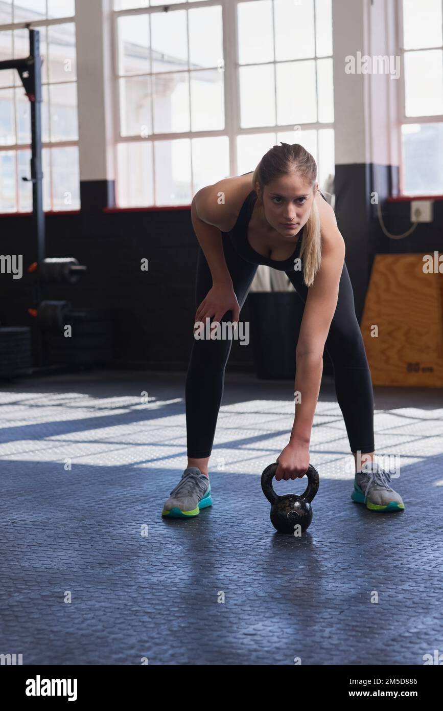 Do it for the after selfie. a young woman doing weight lifting ...