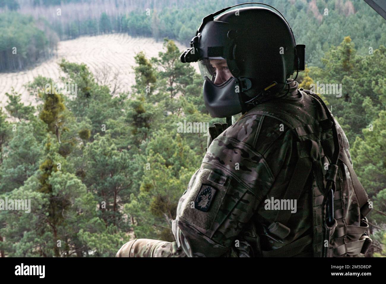 A U.S. Army CH-47 Chinook crew chief views his surroundings during an ...