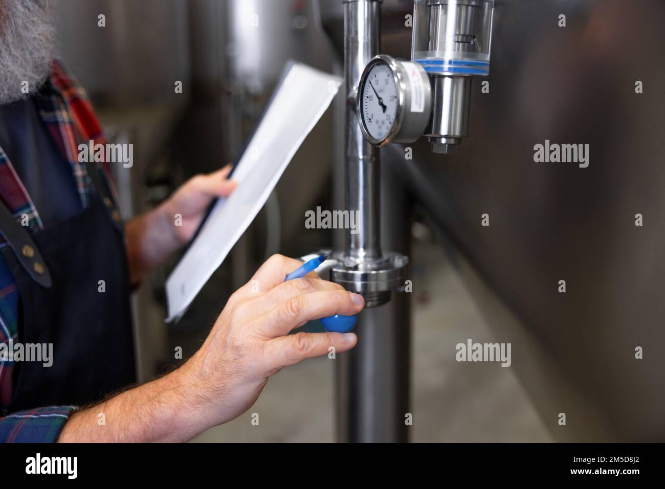 Brewery worker checking the pressure in tanks with beer Stock Photo - Alamy