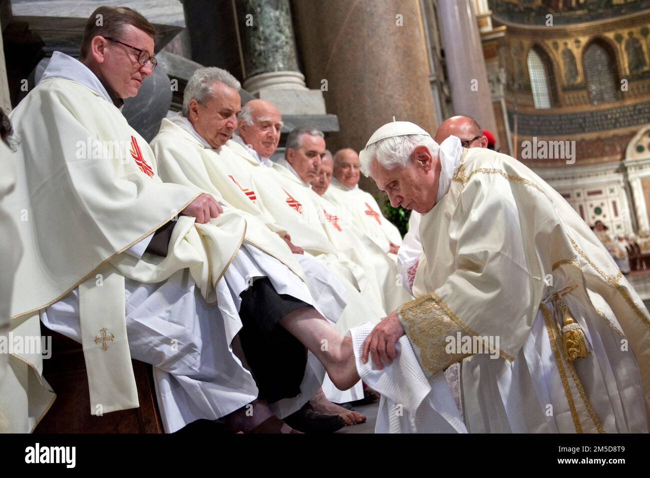 File photo - Pope Benedict XVI washes the foot of a priest, during the ...