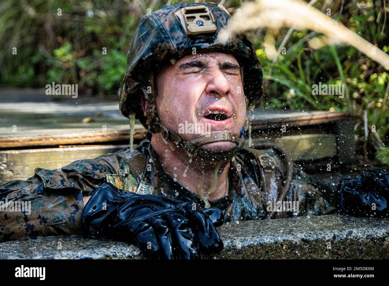 A U.S. Marine with 3rd Marine Expeditionary Brigade, moves through an ...