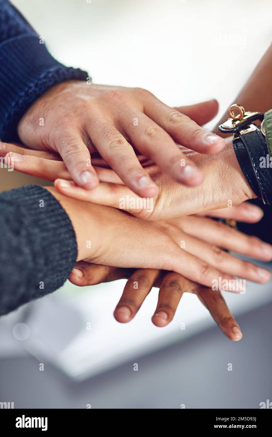Stacking their hands in a teamwork hi-res stock photography and images ...