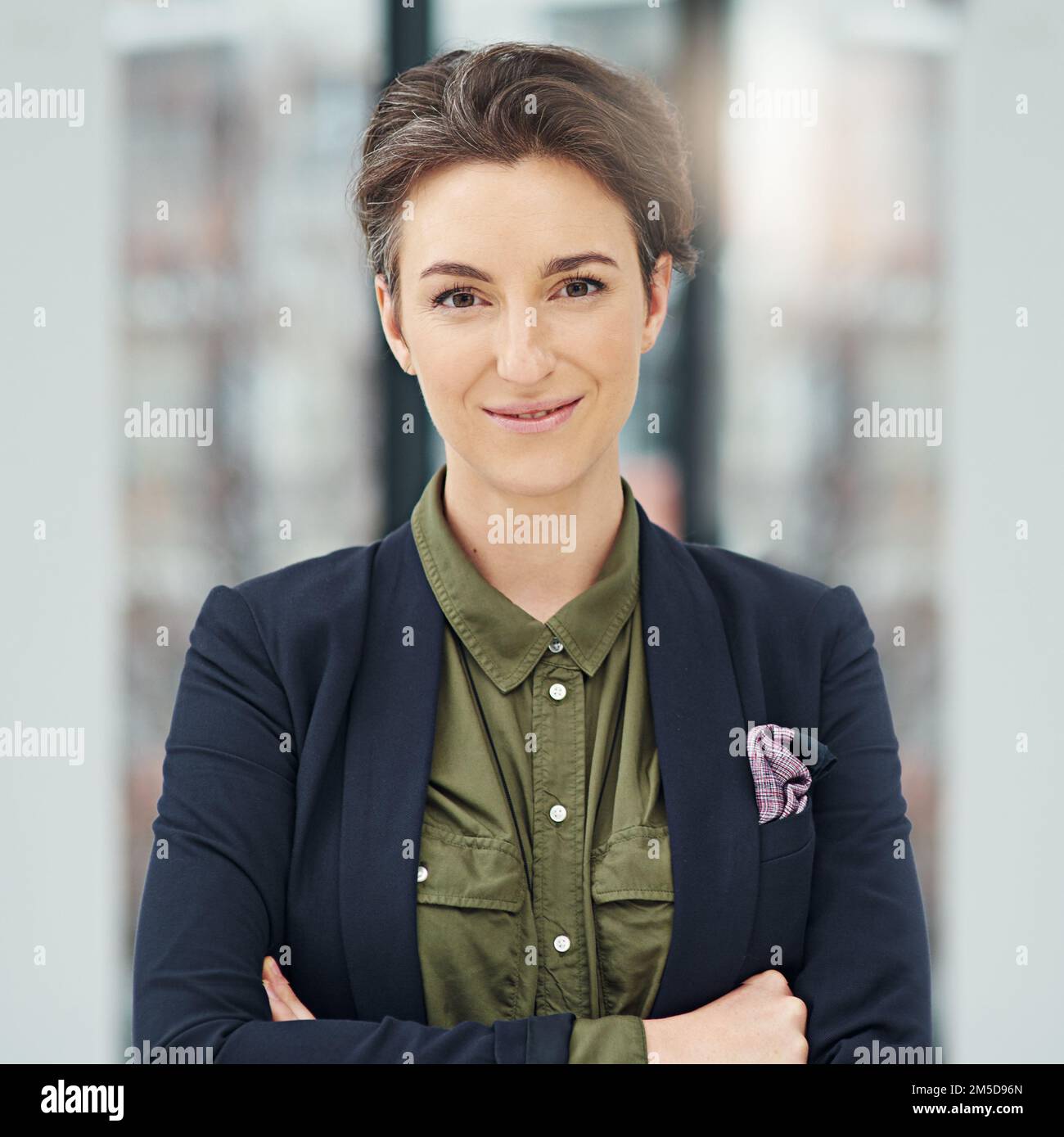 The modern businesswoman. Cropped portrait of a young businesswoman standing with her arms ...