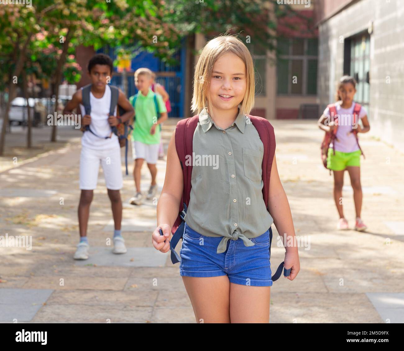 Cheerful preteen girl with backpack going to school on summer day Stock ...