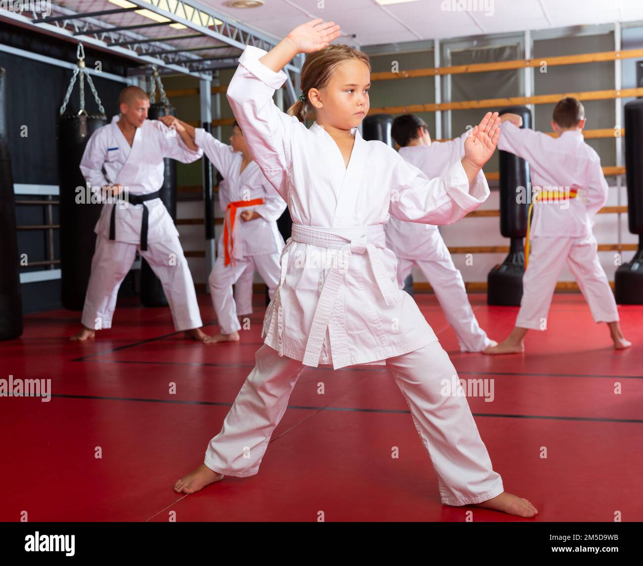 Girl practicing new moves during karate class Stock Photo - Alamy