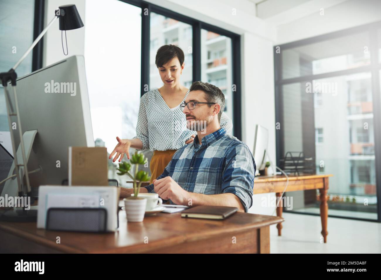 Building a strategy together. Cropped of colleagues working together on ...