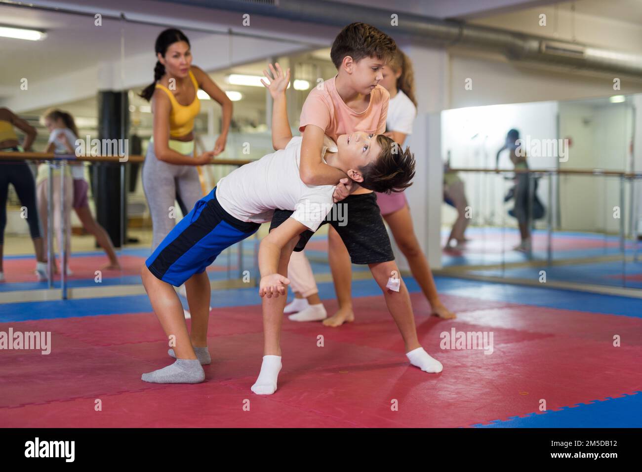Boys and girls learn together in self-defense lesson to do painful head ...
