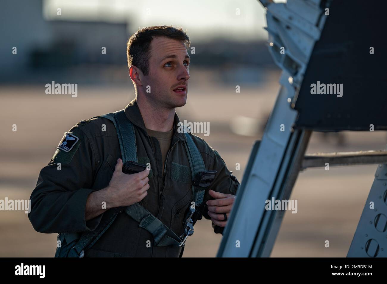 An aircrew member with the 9th Bomb Squadron prepares to climb into a B ...