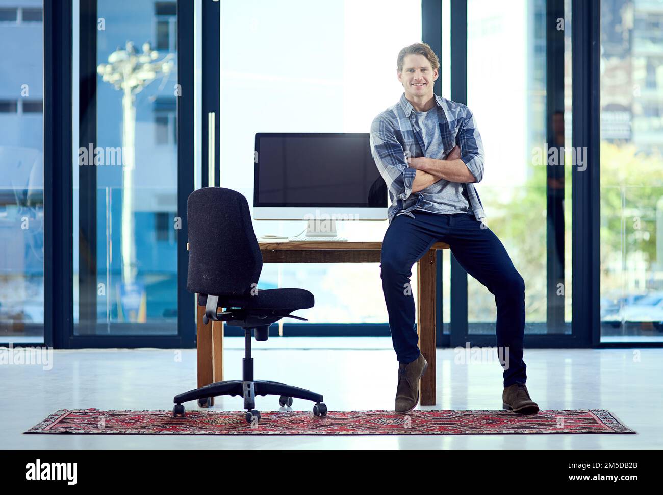 Professional man leaning against desk hi-res stock photography and ...