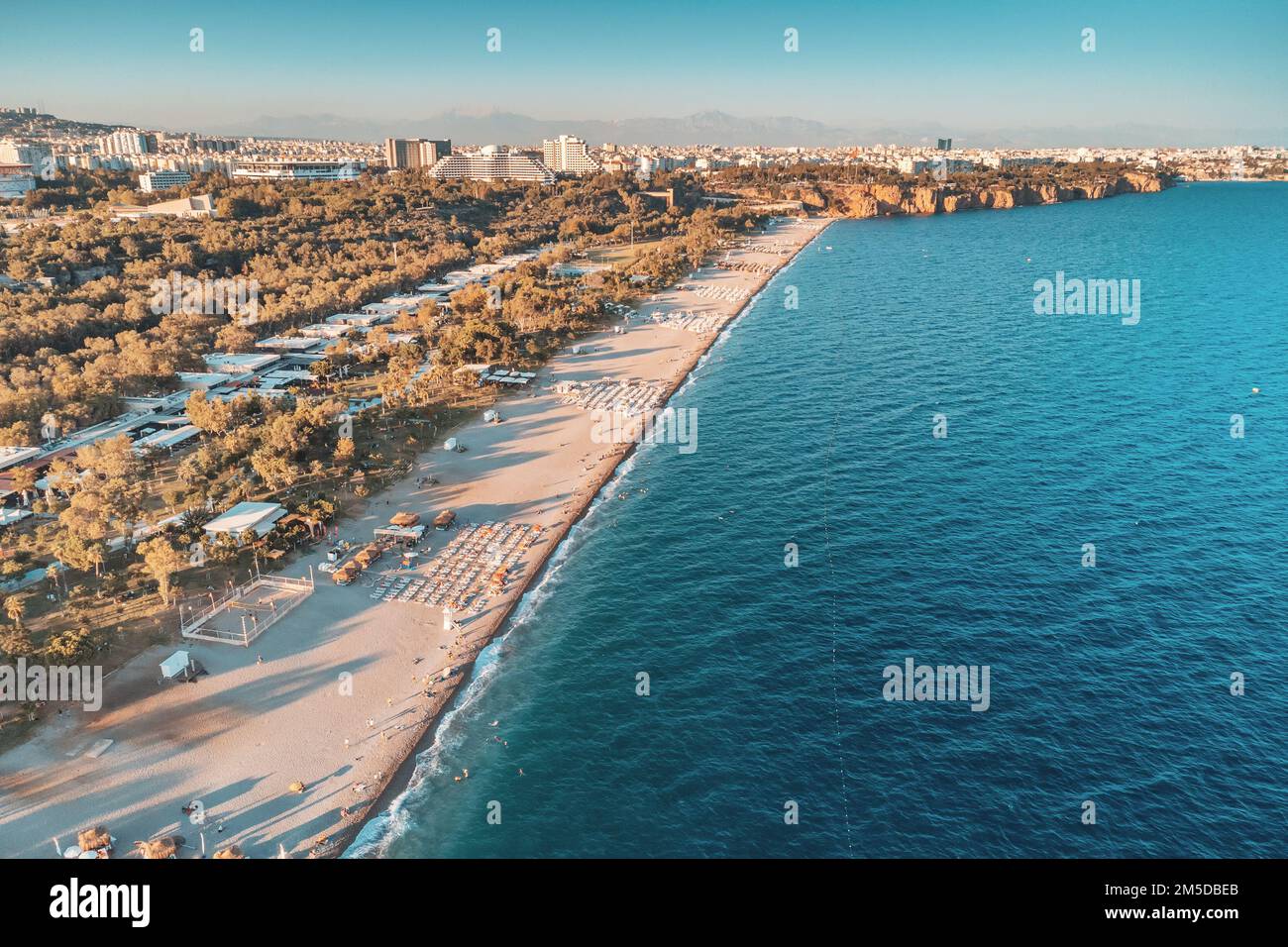 Aerial view of a sunset over beach park with vacationers in Antalya ...