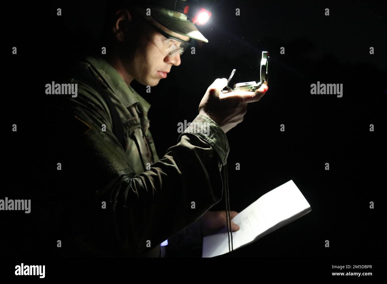Spc. James-Michael Hall, 209th Regional Support Group, uses a headlight ...