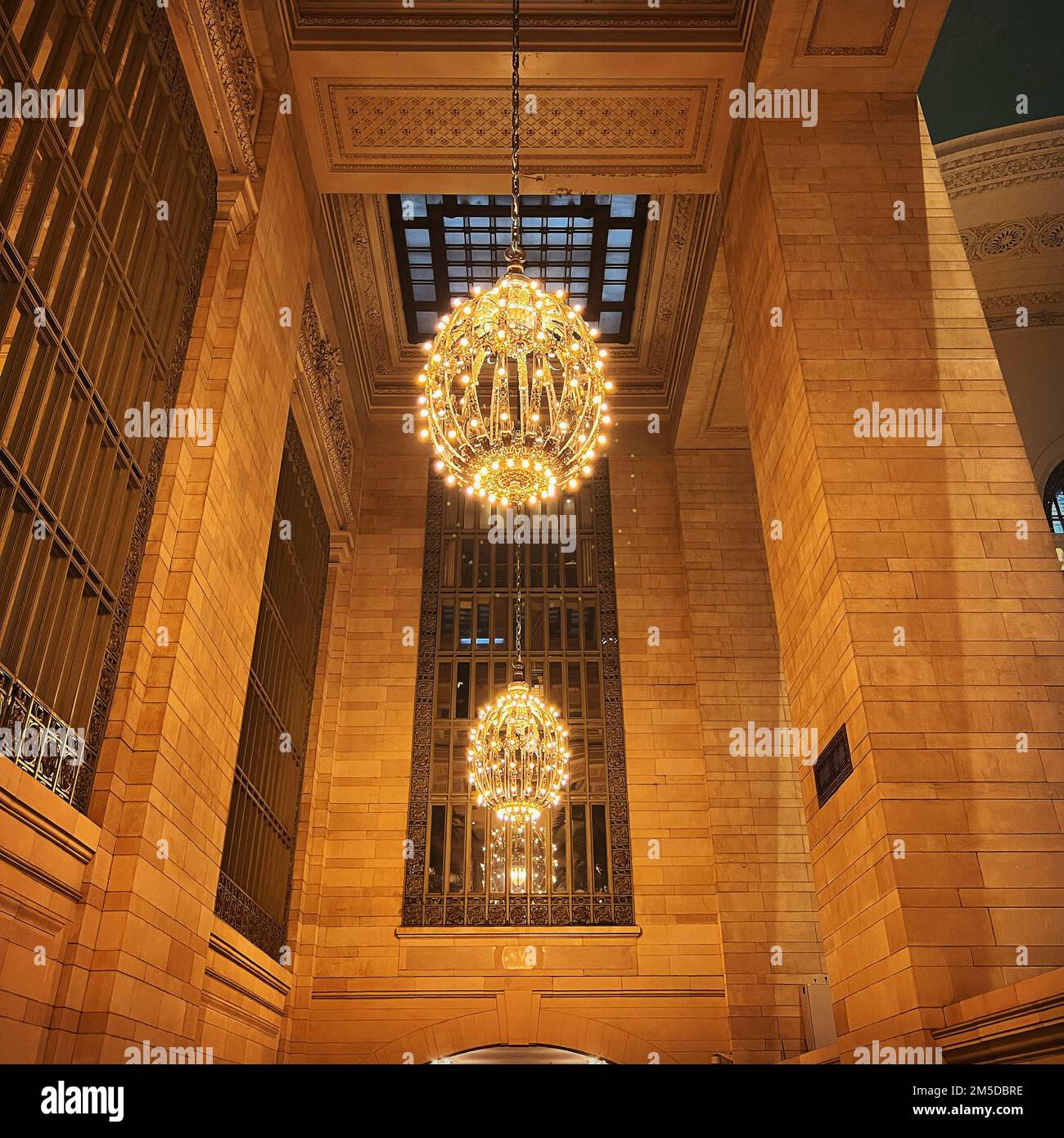 The interior of Grand Central Terminal with a chandelier hanging from ...