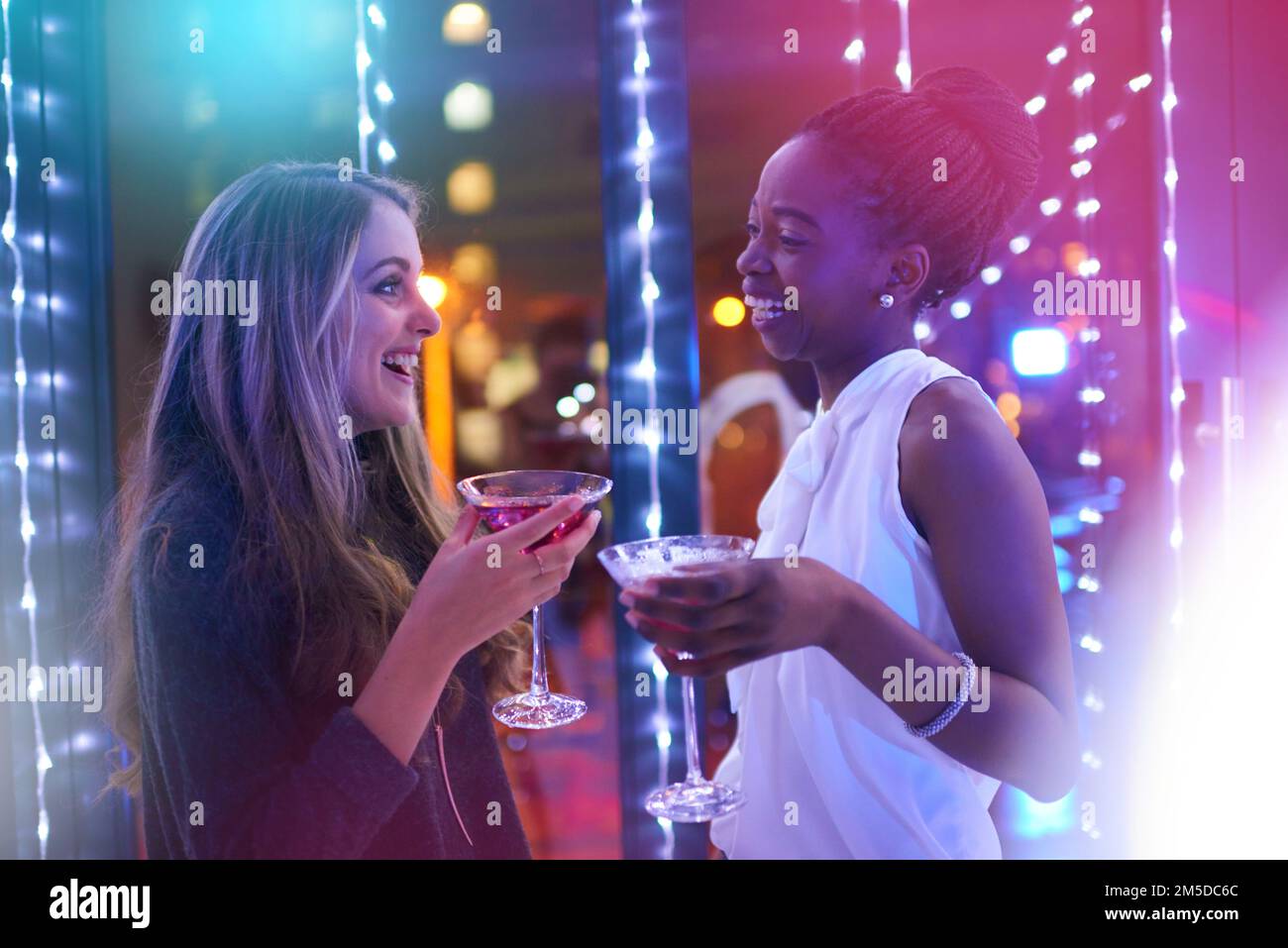 Cocktails and great conversation. two young women having cocktails at a ...