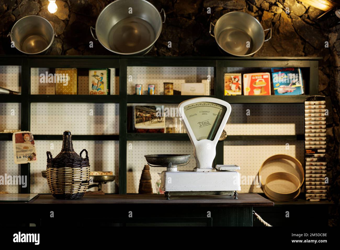 Old fashioned 1950's weighing scales on the shop counter in a ...