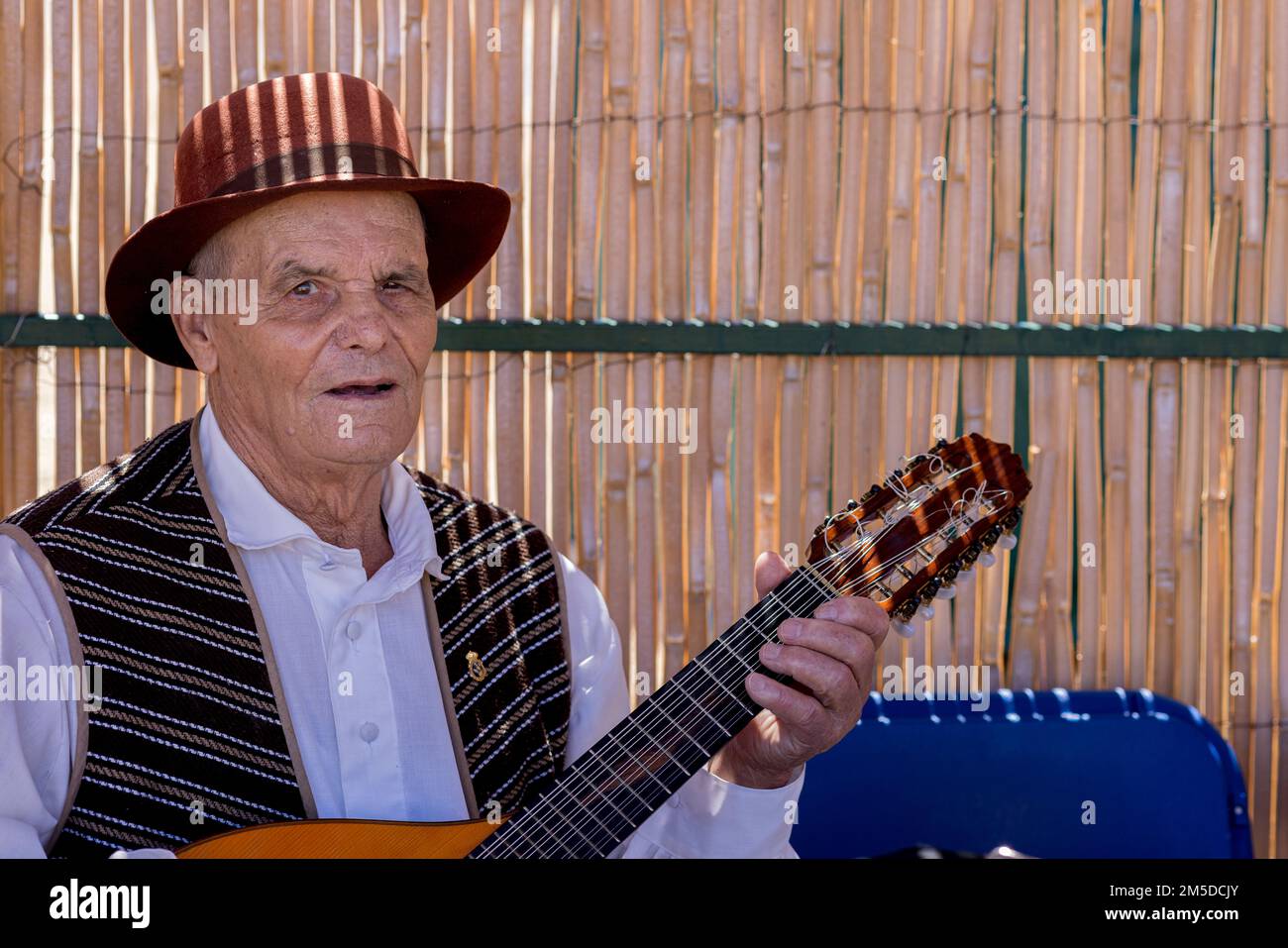 Musicians with a folkloric group tune up before performing at the ...