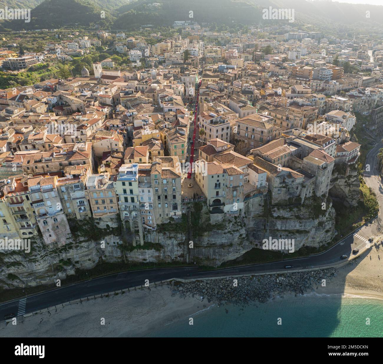 Aerial view of Tropea, houses on the rocks. Roofs and windows. Sunset ...