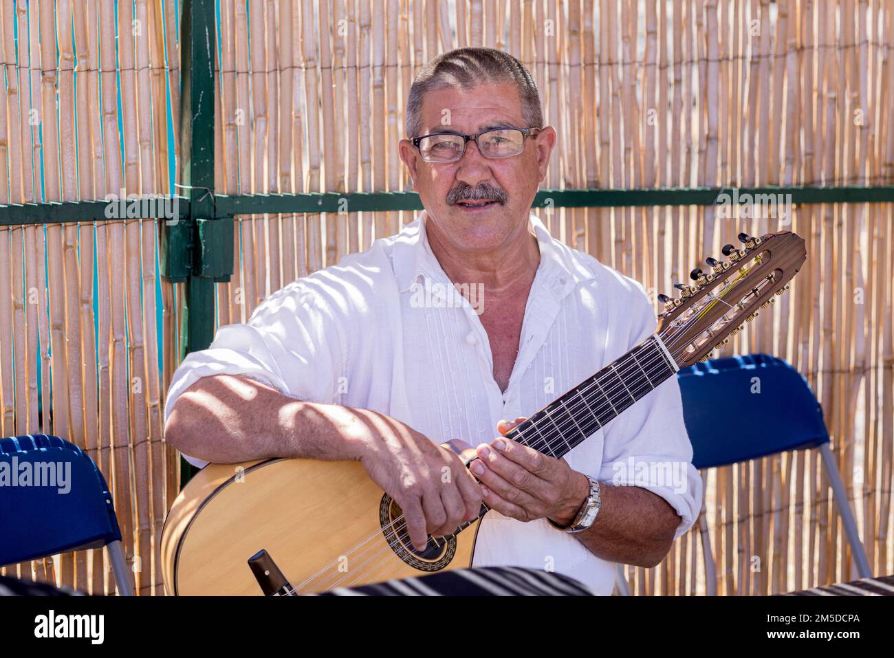 Musicians with a folkloric group tune up before performing at the ...