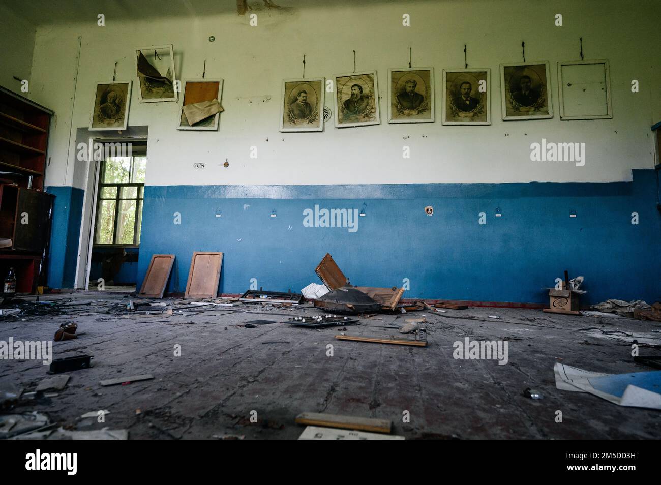Abandoned old classroom with blue painted walls, dark horrible and ...