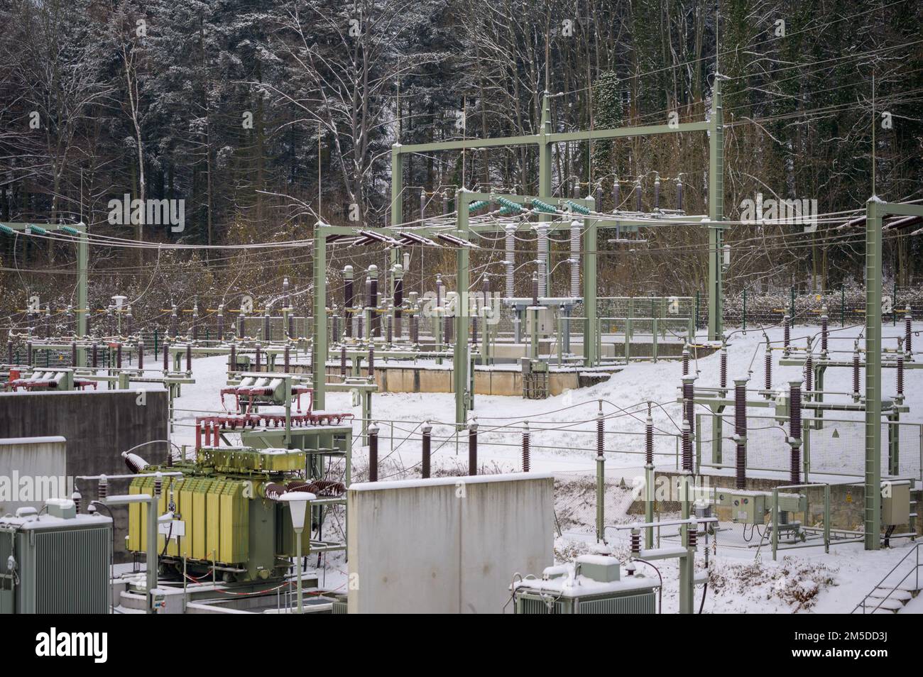 Electrical substation in winter with snow covered transformers and ...