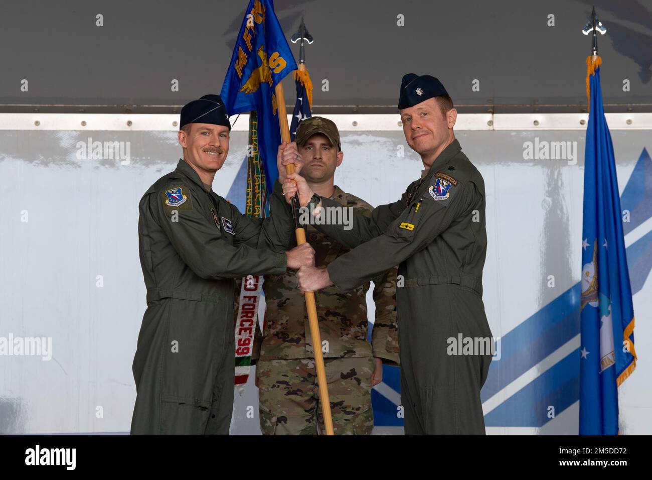 U.S. Air Force Col. Justin Spears, 14th Operations Group commander, left, passes the 14th Flying ...