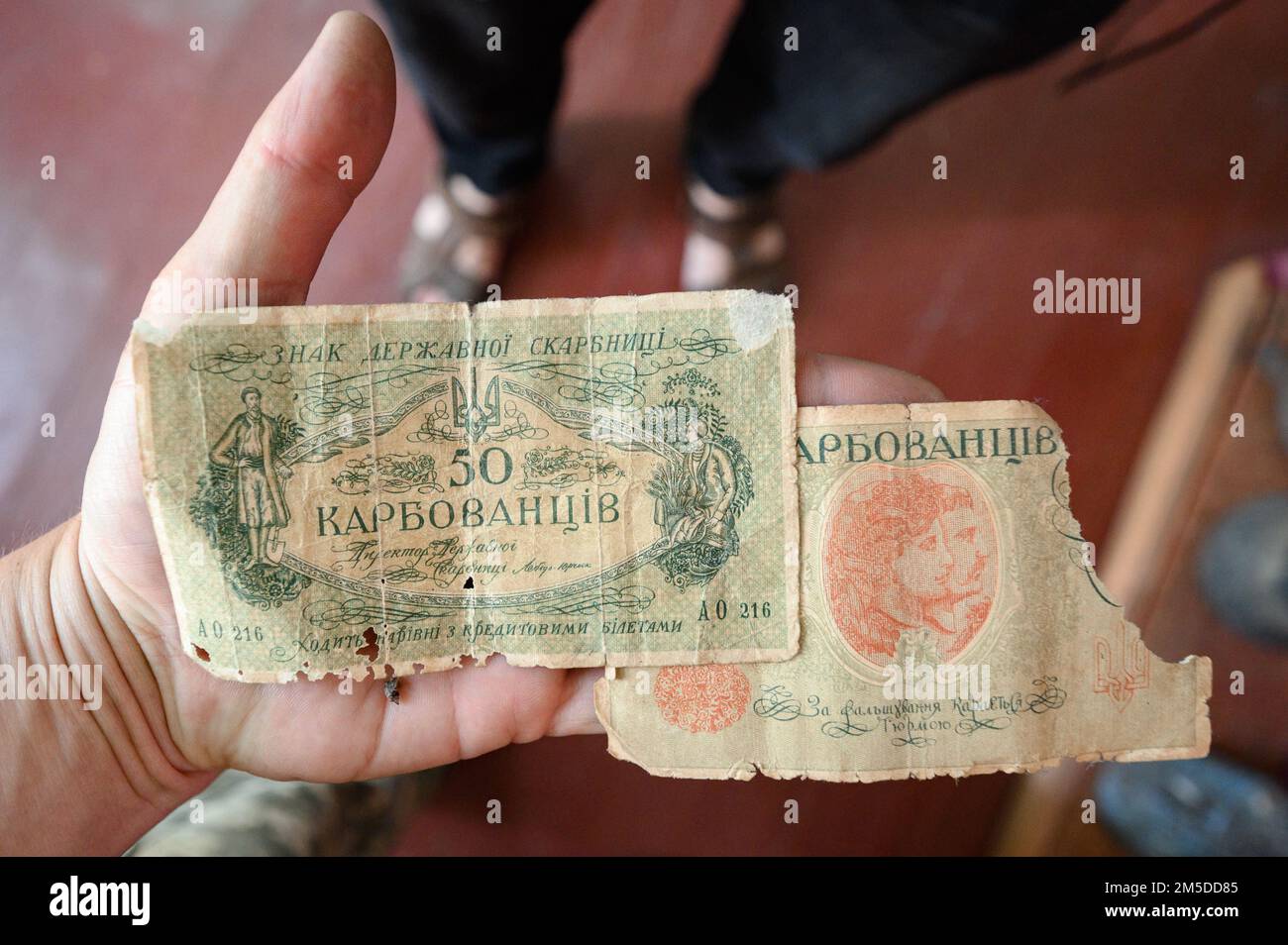 Kyiv, Ukraine, July 1, 2022: a man holds in his hands the old Ukrainian ...