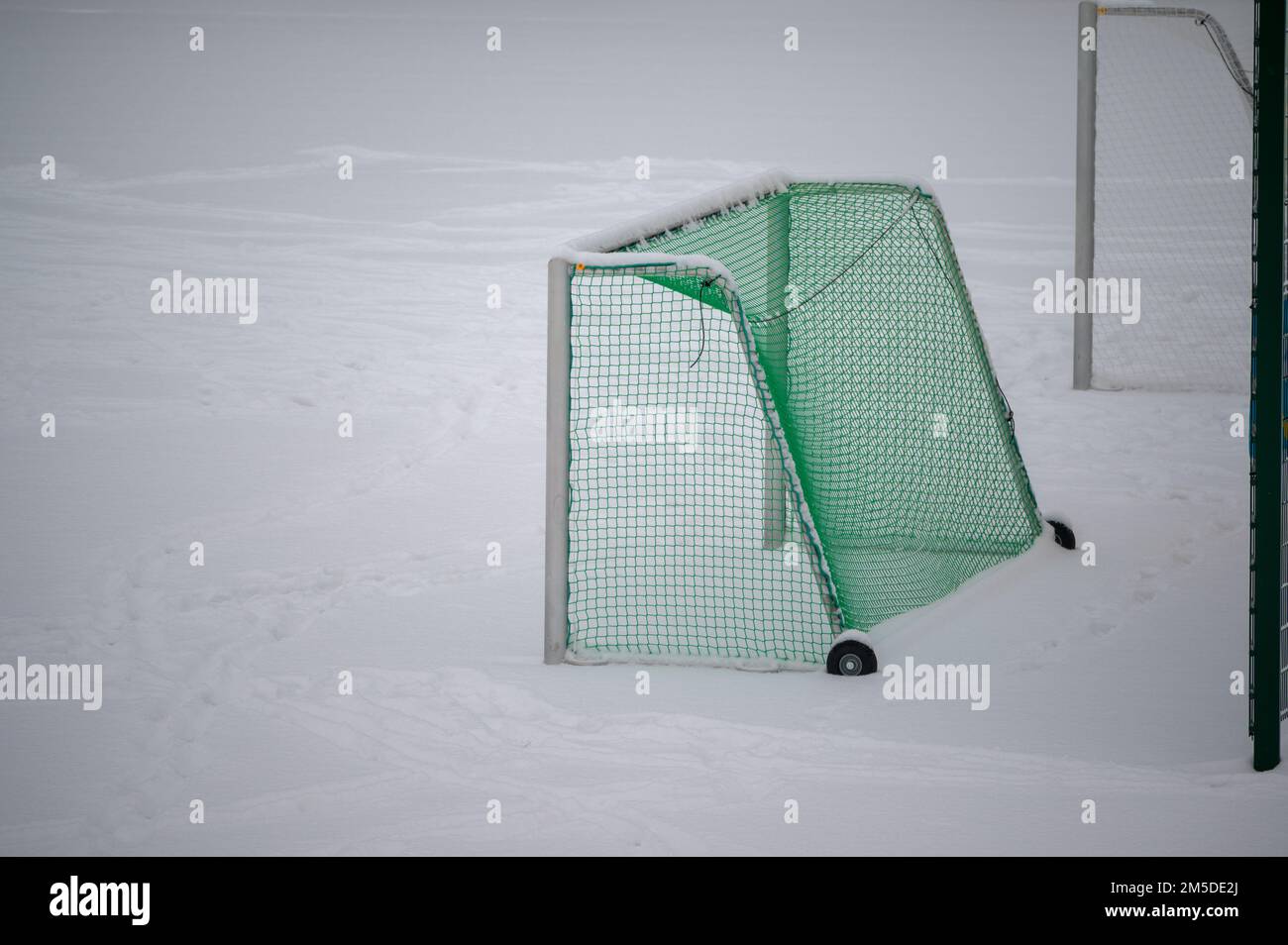 Soccer goal with green netting and pitch under snow in winter Stock ...