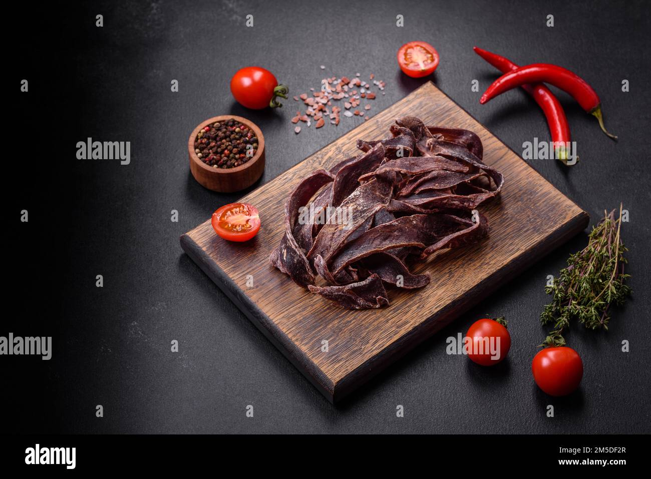 Delicious salted dried beef cut into slices as an appetizer for beer on ...
