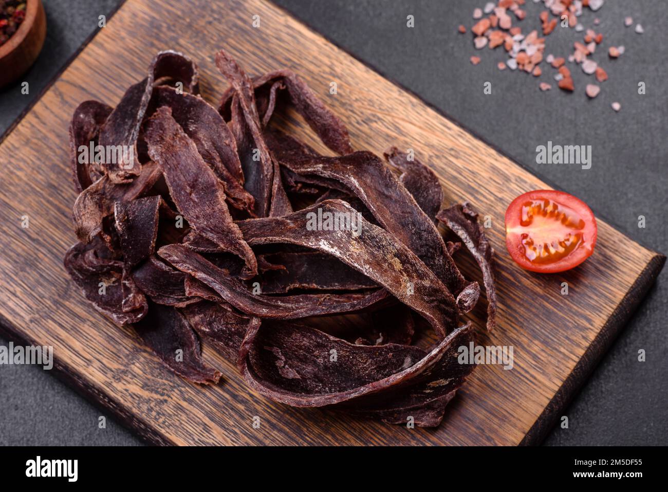 Delicious salted dried beef cut into slices as an appetizer for beer on ...