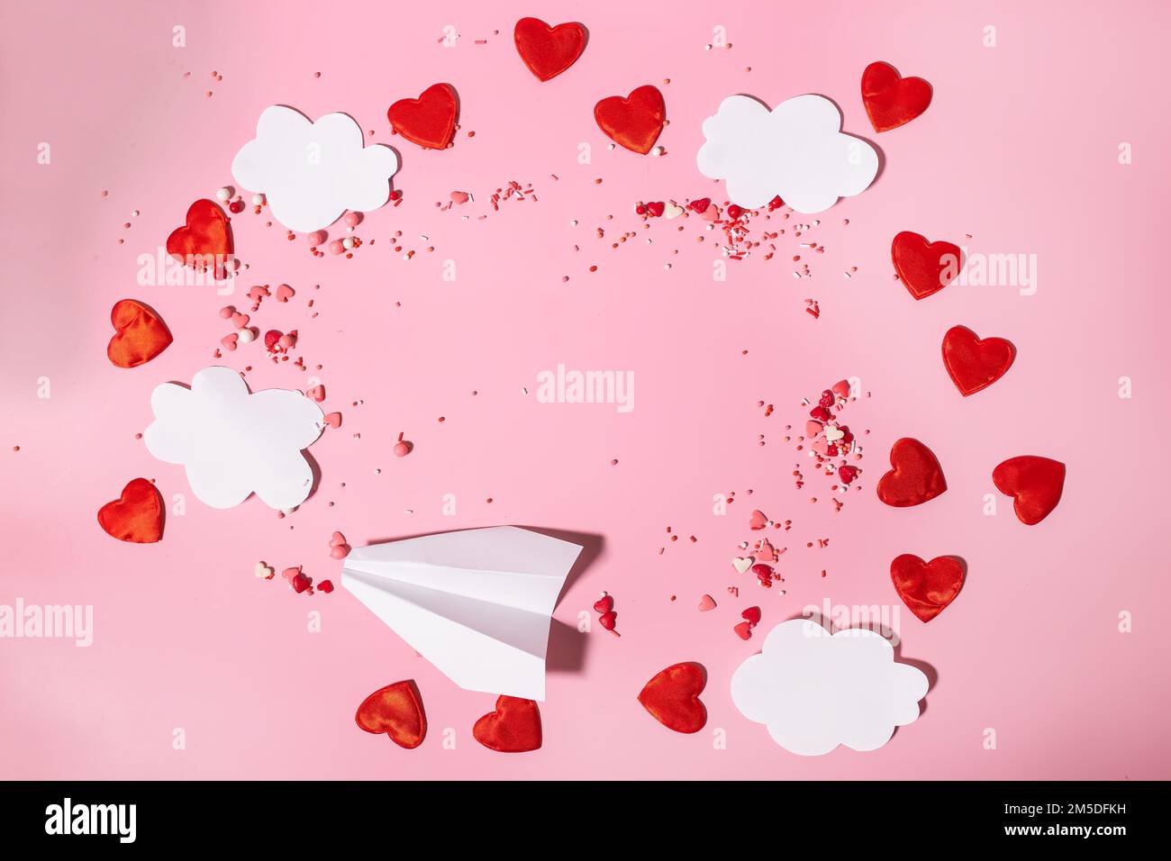 A frame of paper clouds, hearts and a paper airplane for Valentine's ...