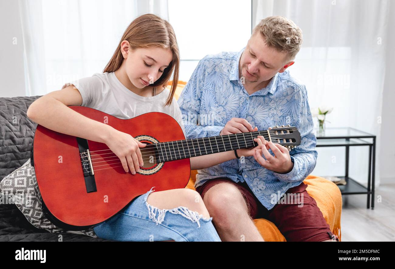 Girl teenager practicing guitar playing Stock Photo - Alamy
