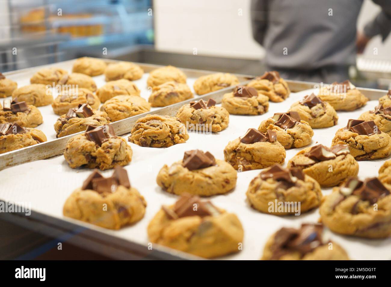 Baking tray with tasty cookies taken out from oven at a bakery shop ...
