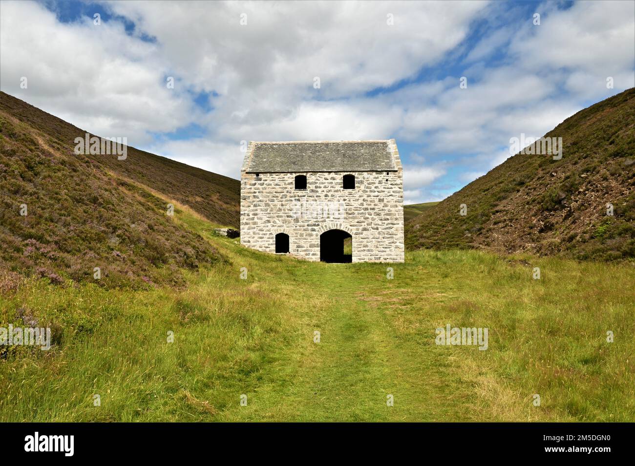 An exterior view of the ruins of the old Lecht Iron mine building in ...
