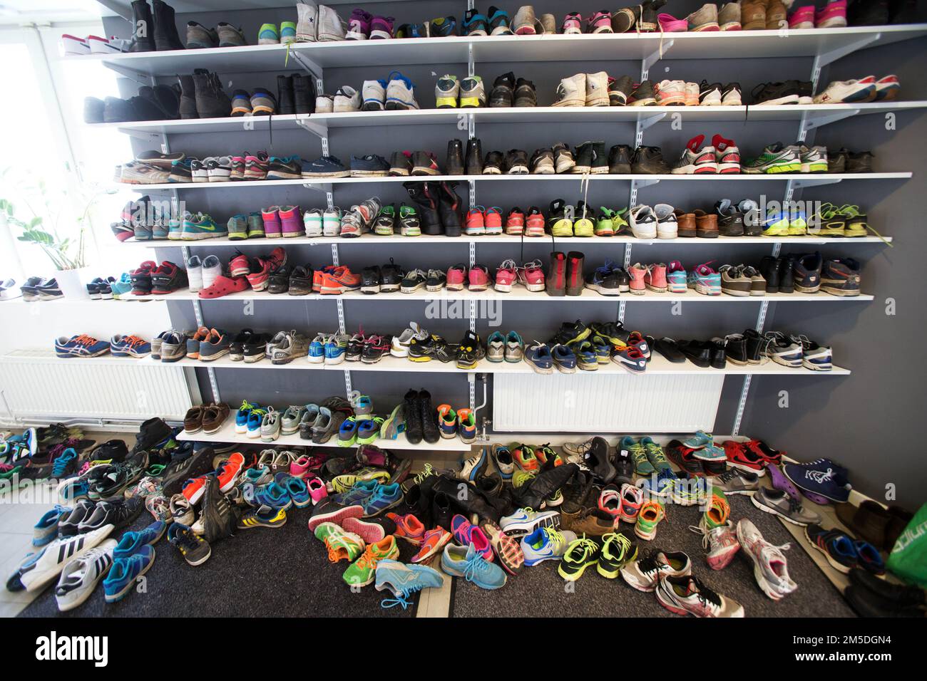 Shoes on shoe rack at an event Stock Photo - Alamy