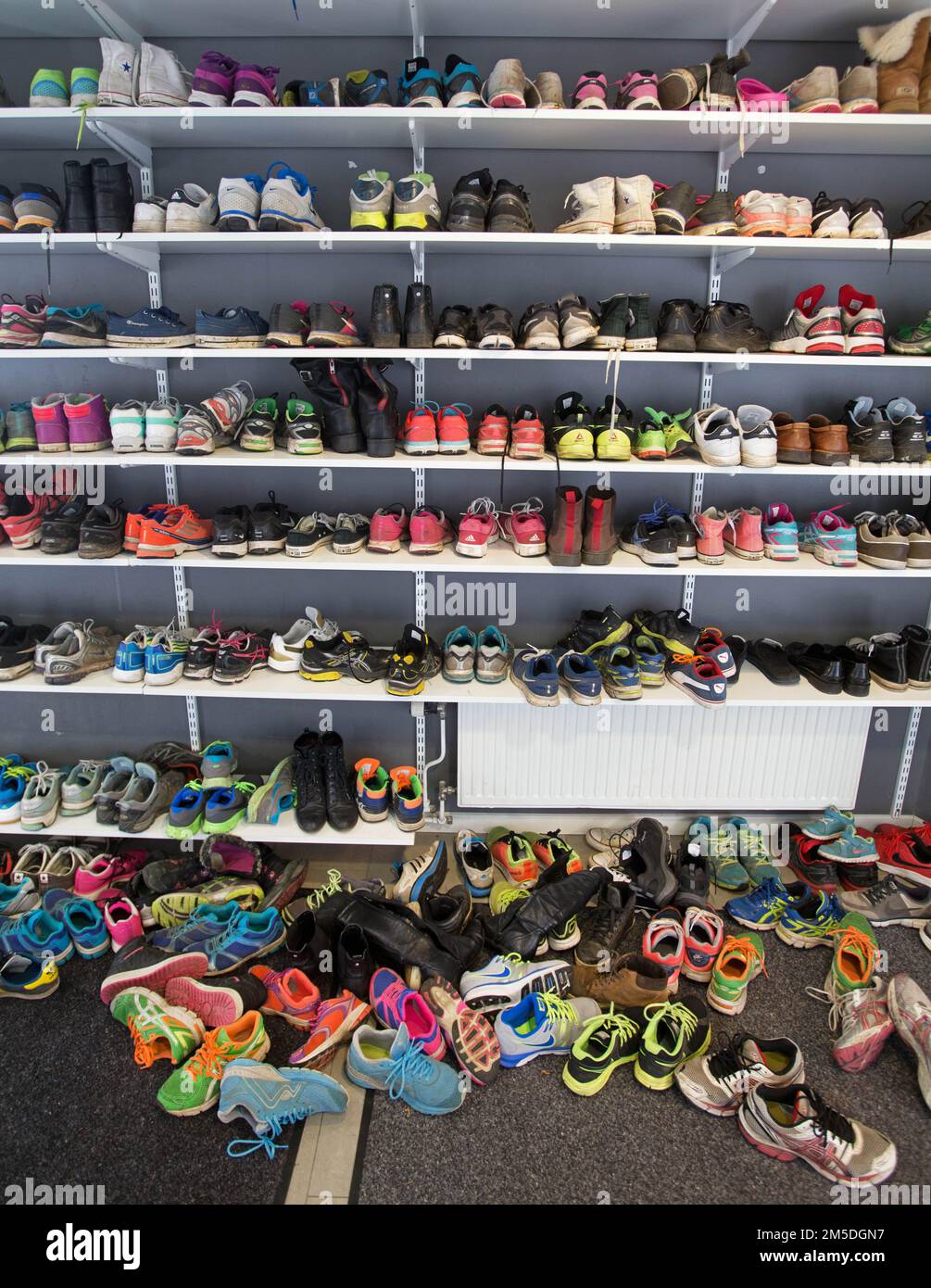 Shoes on shoe rack at an event Stock Photo - Alamy